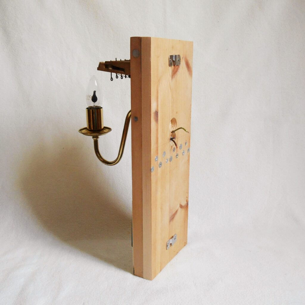 A pair of repurposed wall lamps with antique piano keys ...