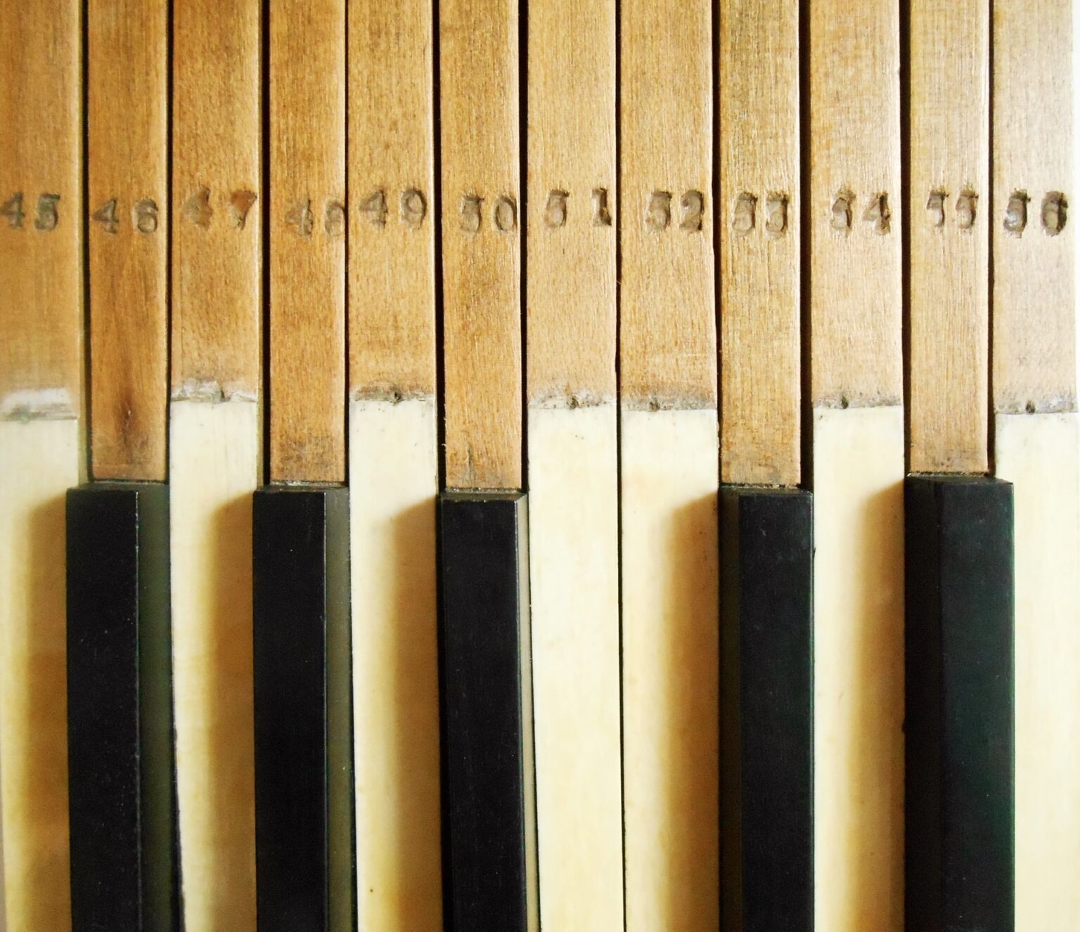 A pair of repurposed wall lamps with antique piano keys ...