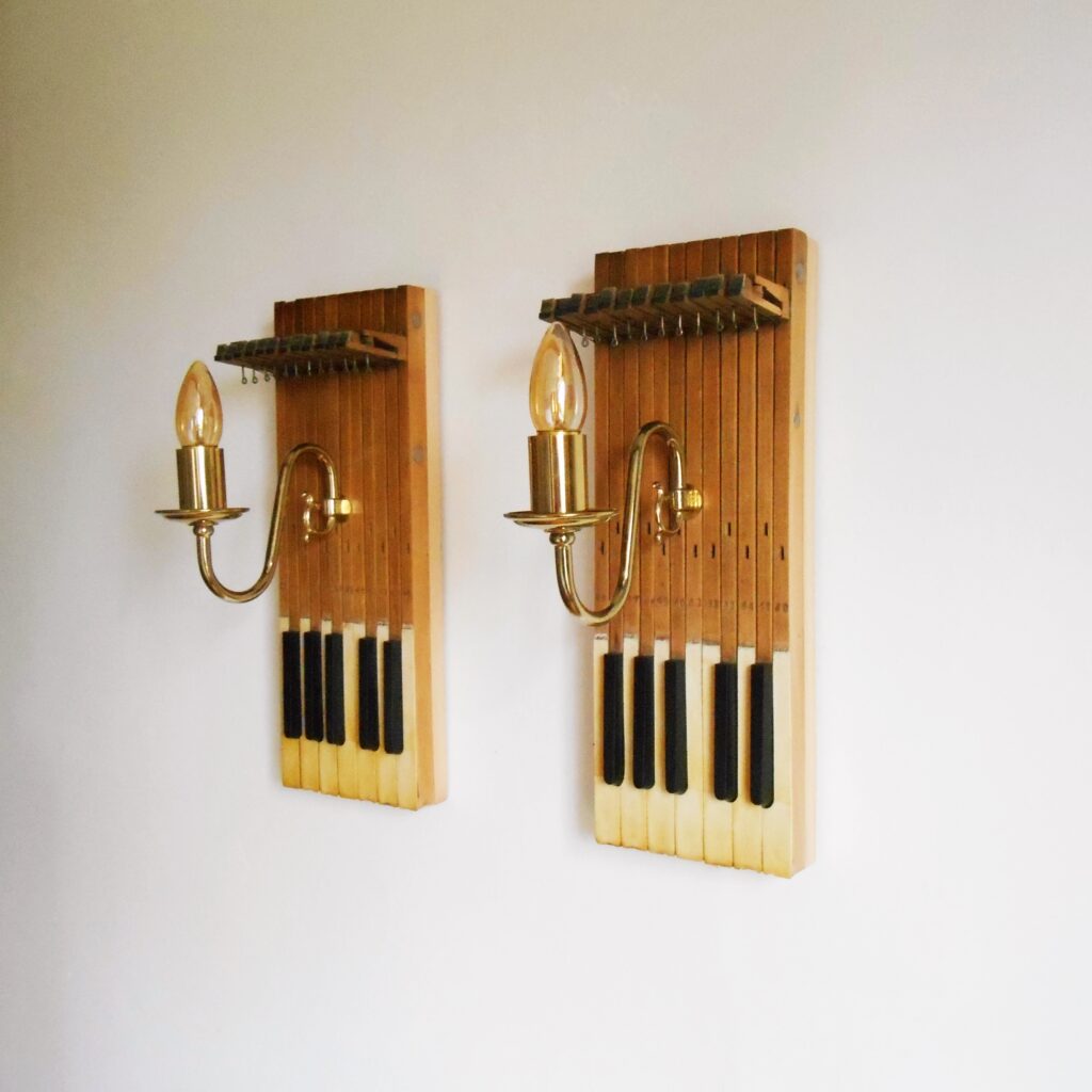 A pair of repurposed wall lamps with antique piano keys ...